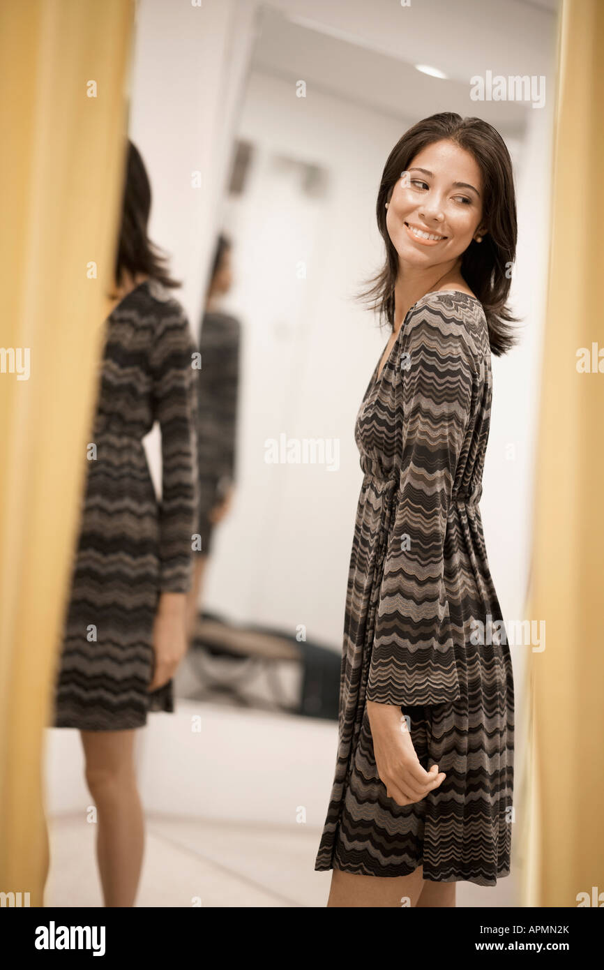 Young woman trying dress on Stock Photo - Alamy Young woman trying dress on Stock Photo - Alamy