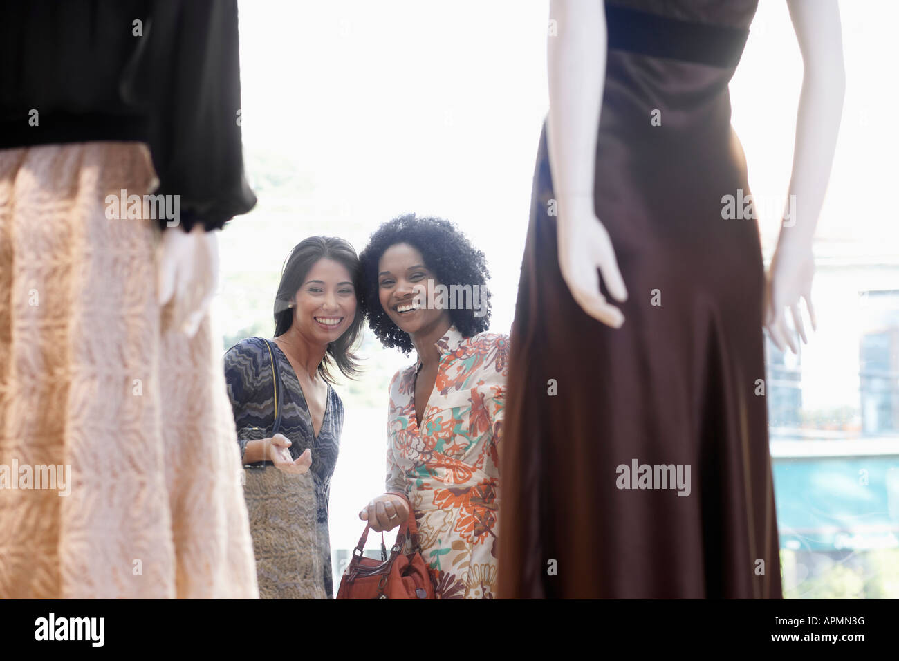 Young women window shopping dresses Stock Photo - Alamy
