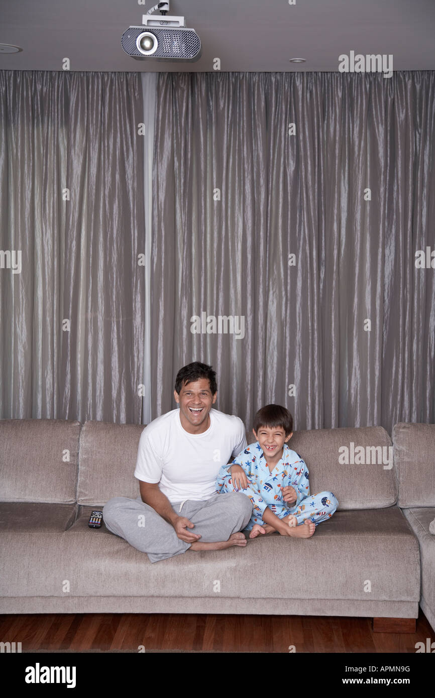 Father and son watching TV Stock Photo - Alamy
