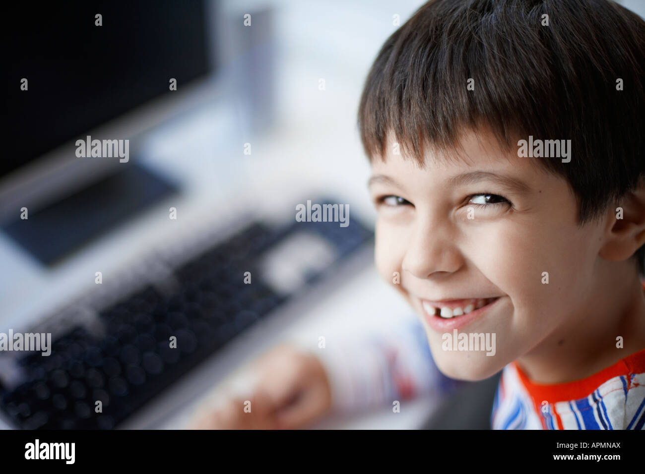 Boy near computer (portrait Stock Photo - Alamy