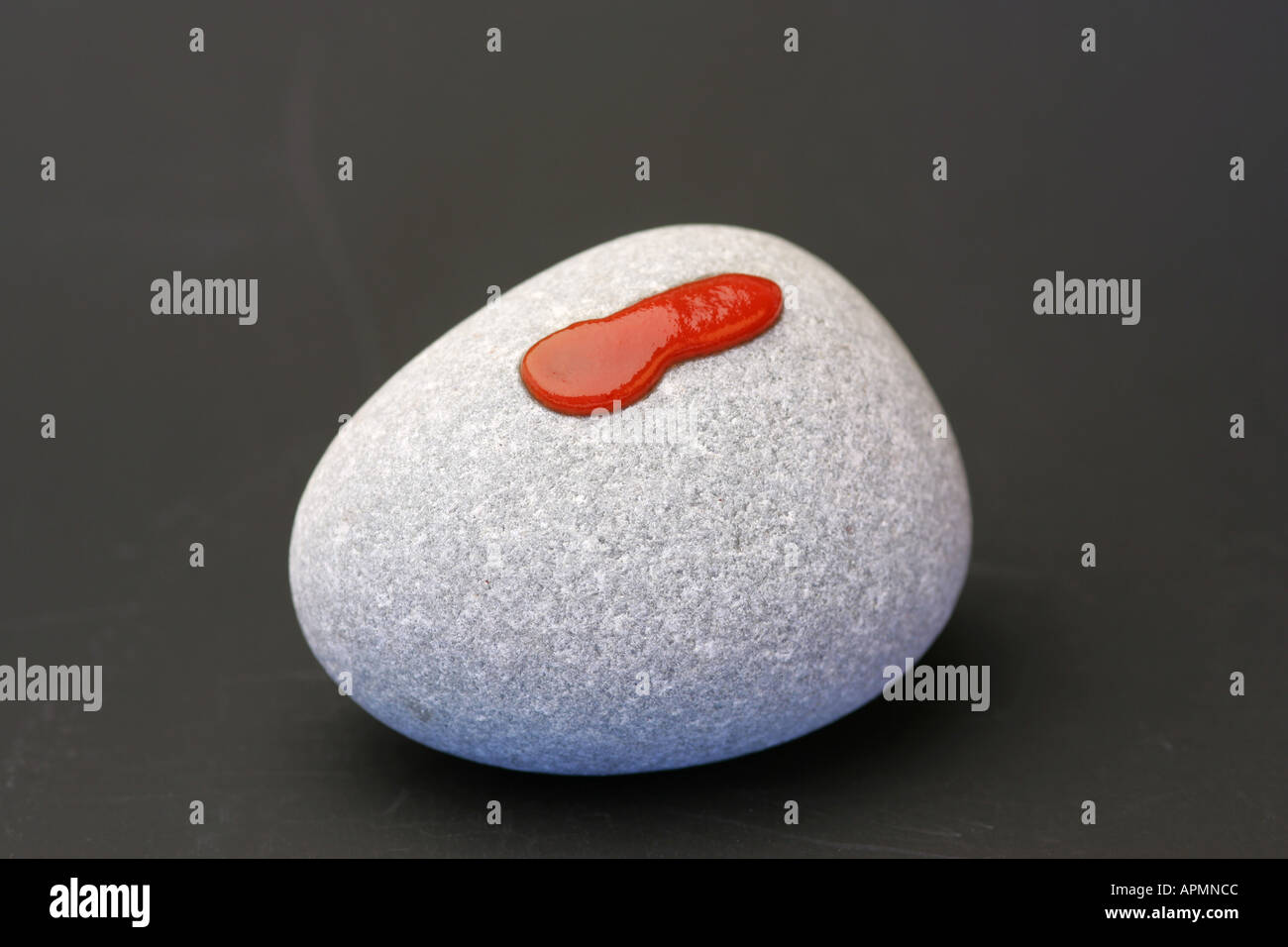 Blood from a stone bright red vivid viscous blood seeps from a round ...