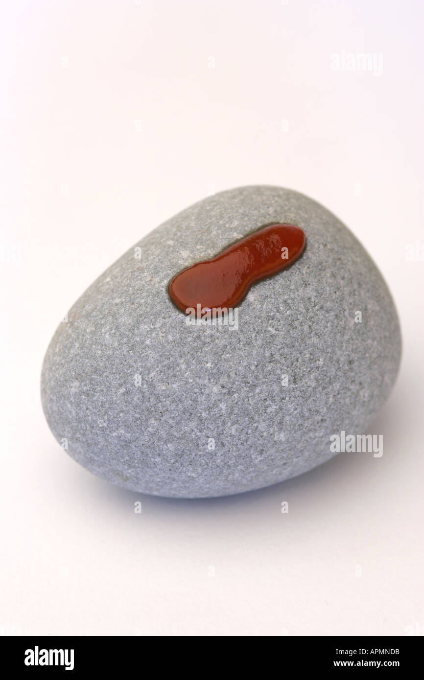 Blood from a stone bright red vivid viscous blood leaks from a round ...