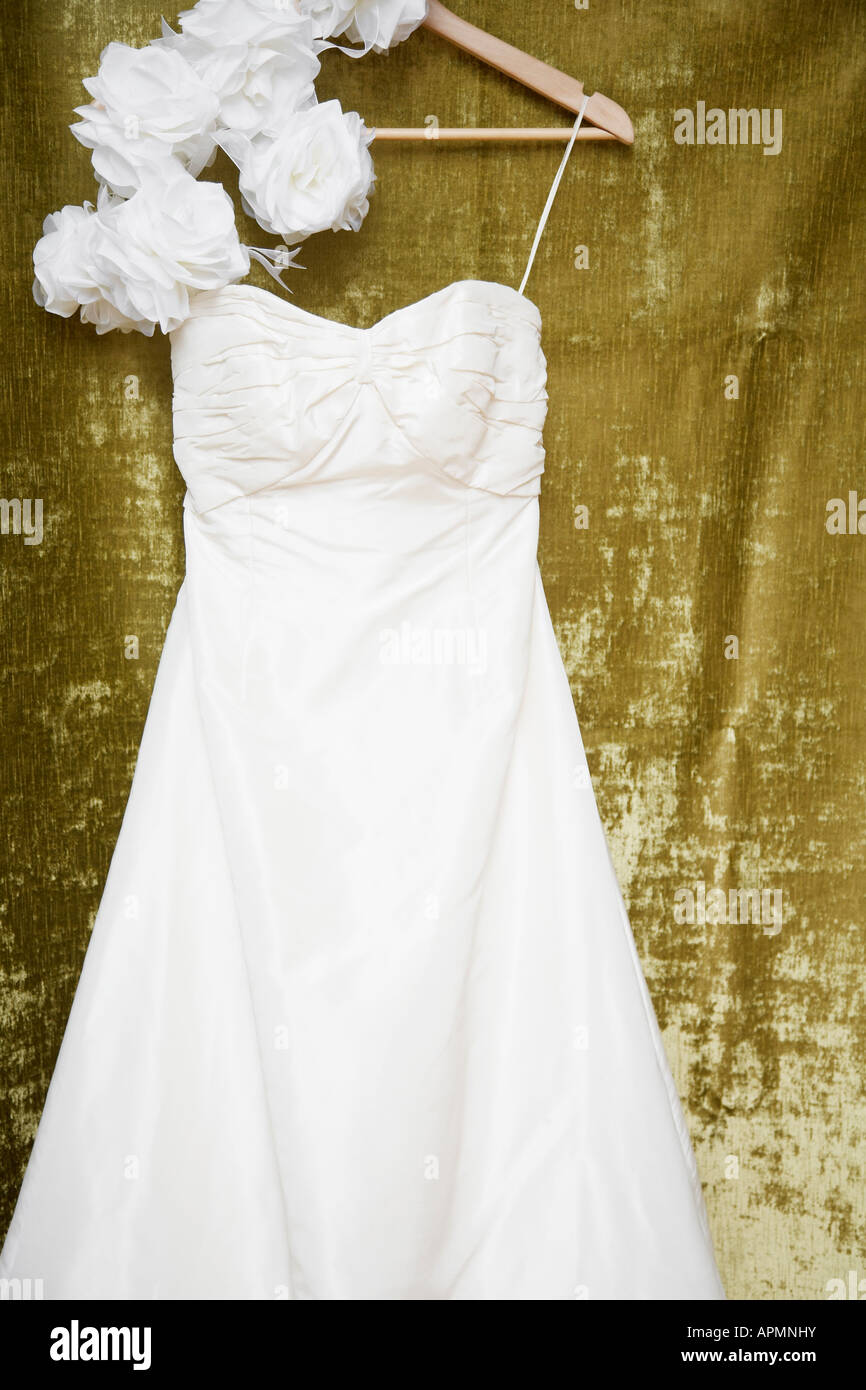 Rose flowers and wedding dress on clothes hanger Stock Photo - Alamy