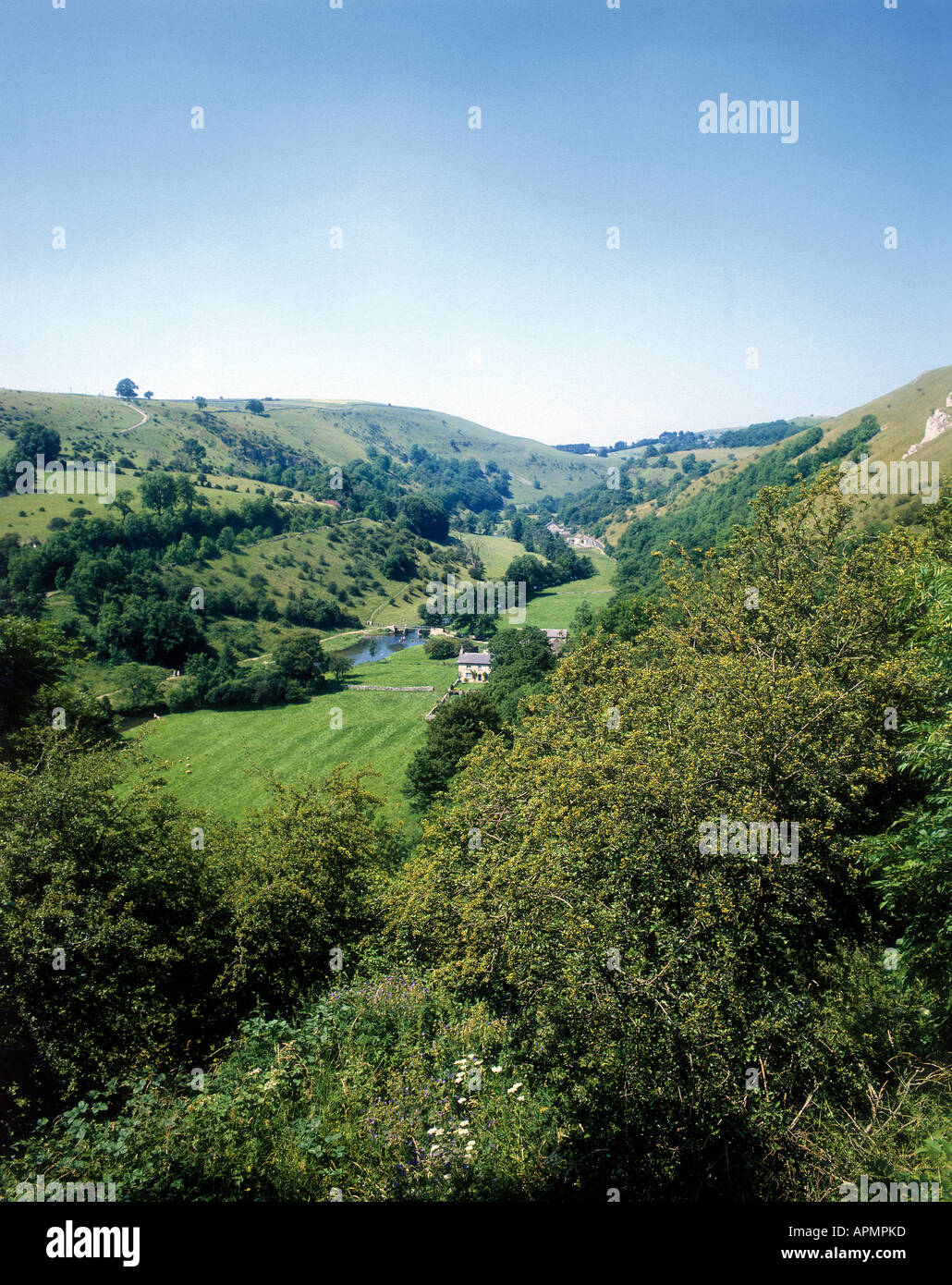 View into a valley at Monsal Dale showing the river hills and cottages ...
