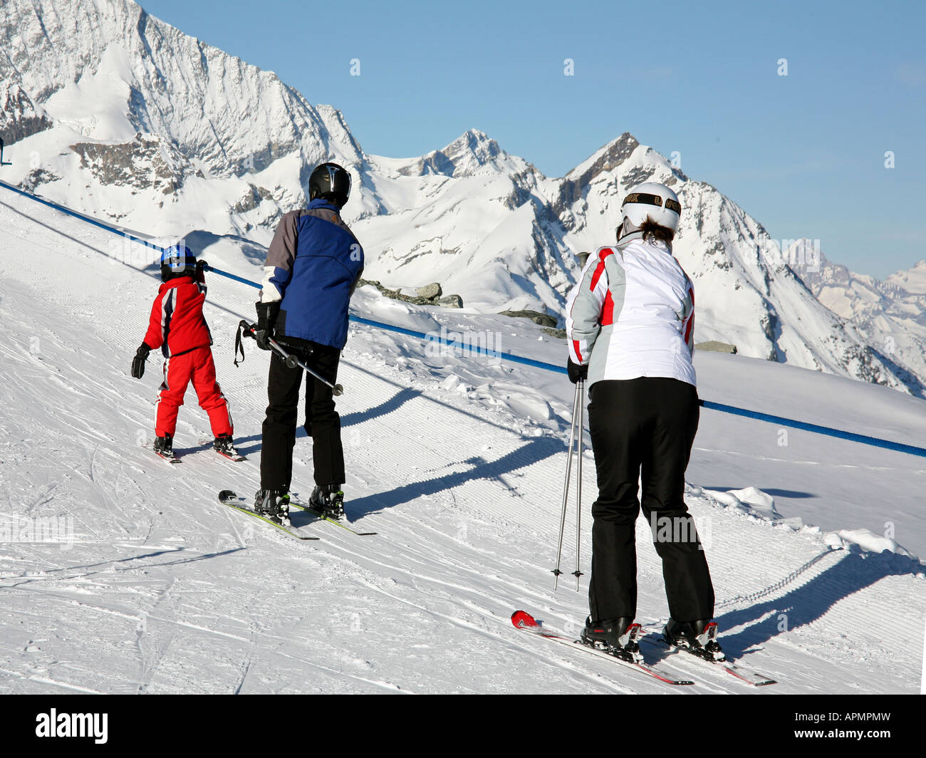 Family group of skiers on the drag lift at Trockener Steg Furgg Zermatt ...