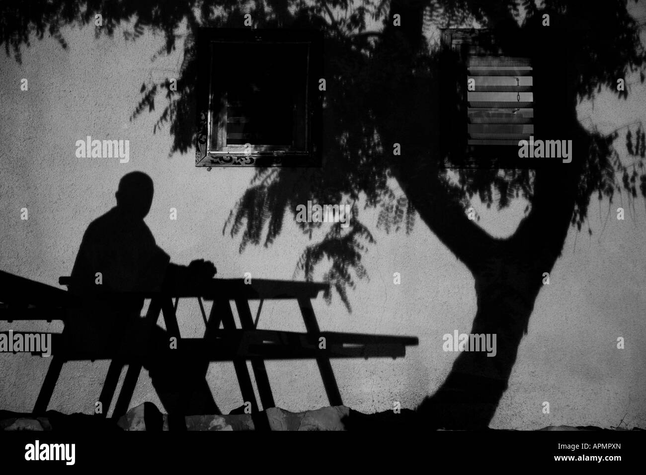 Stock Photo Shadow of Man at Picnic Table Stock Photo - Alamy