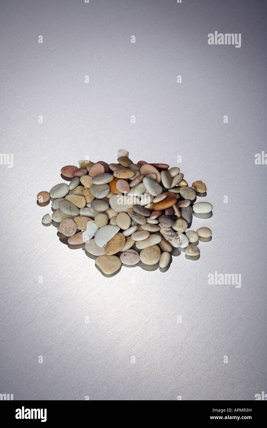 Group of small sea pebbles on gray metal background Stock Photo - Alamy