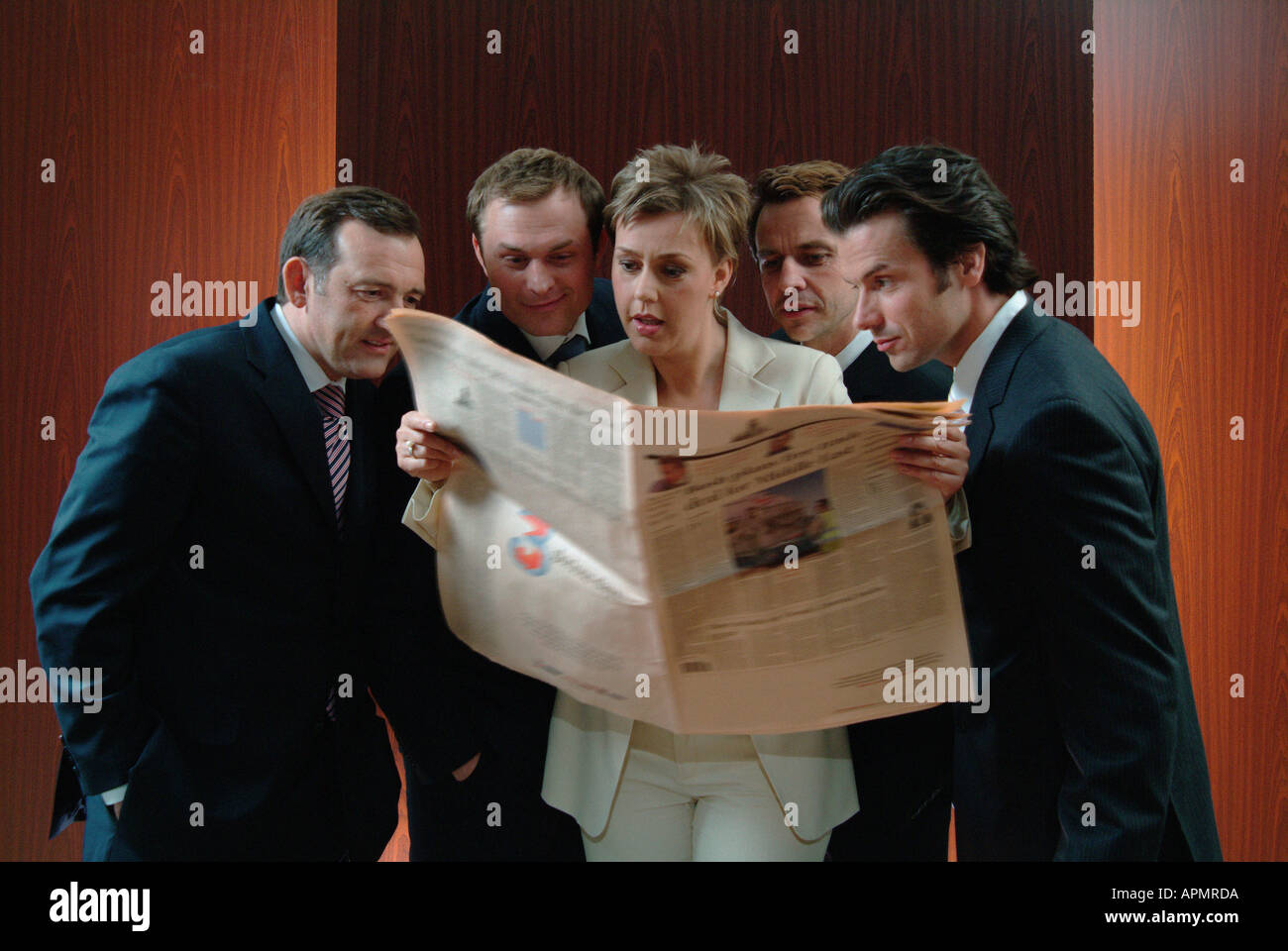 Business people reading paper Stock Photo - Alamy