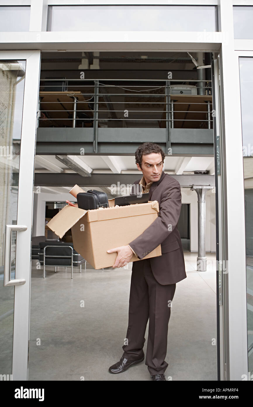 Businessman carrying work belongings hi-res stock photography and ...