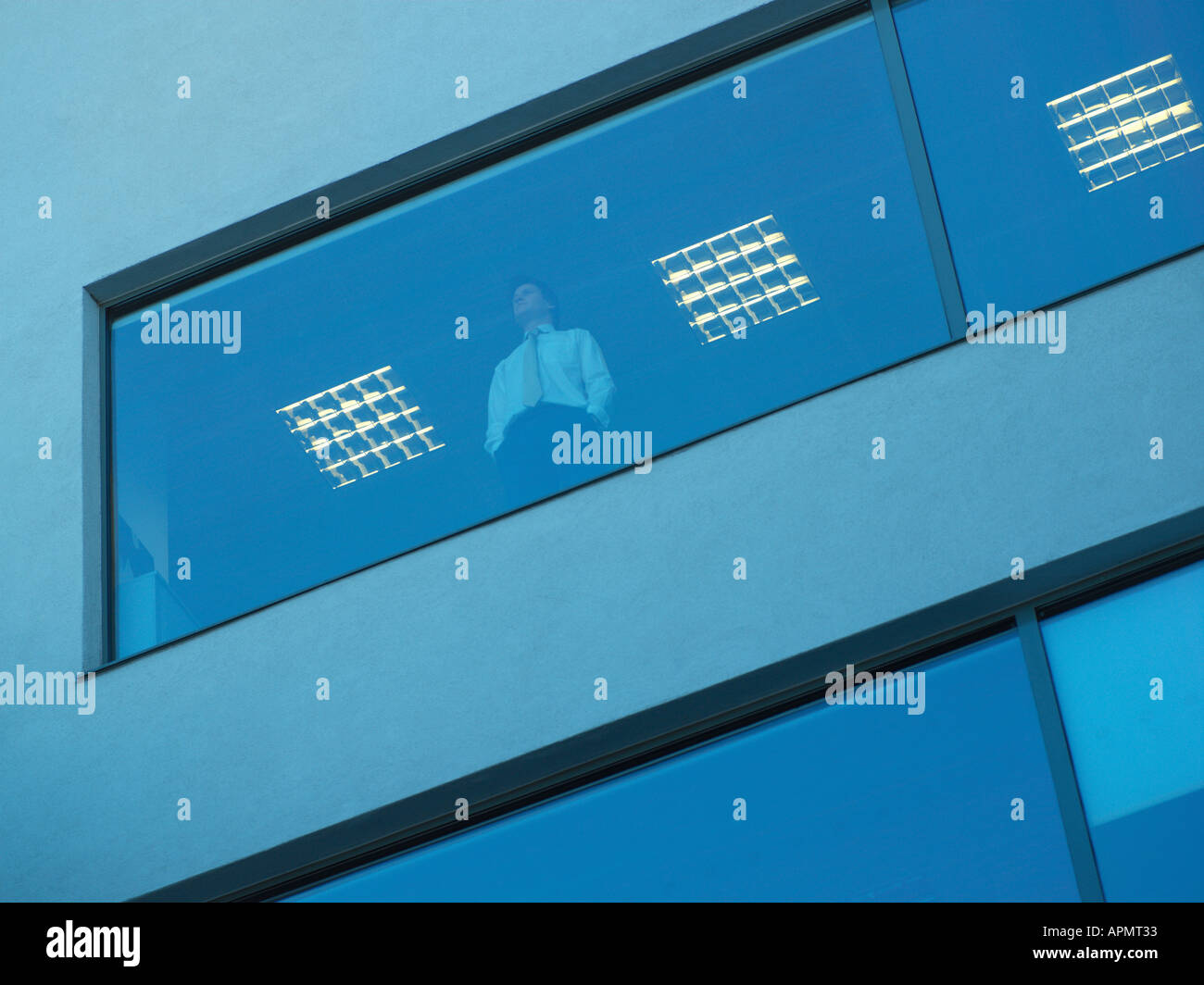 View of businessman through a window Stock Photo - Alamy