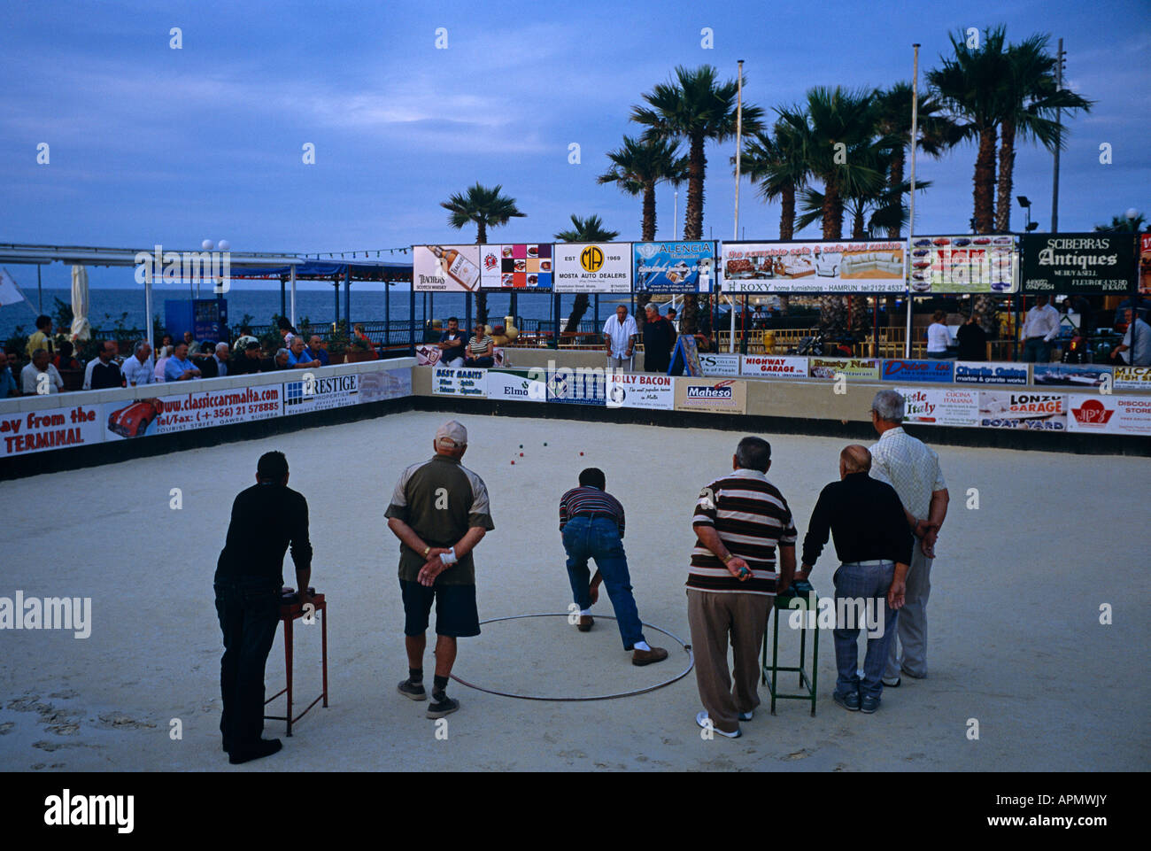 Six men playing Bocce a type of Boule on a special pitch complete with ...