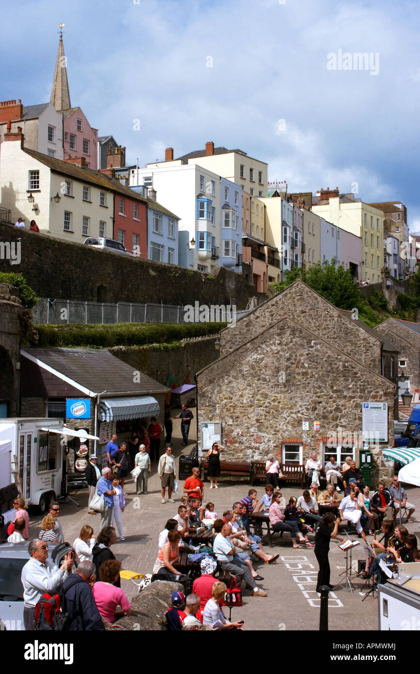 hilltop houses looking down over Tenby harbour, band entertaining ...