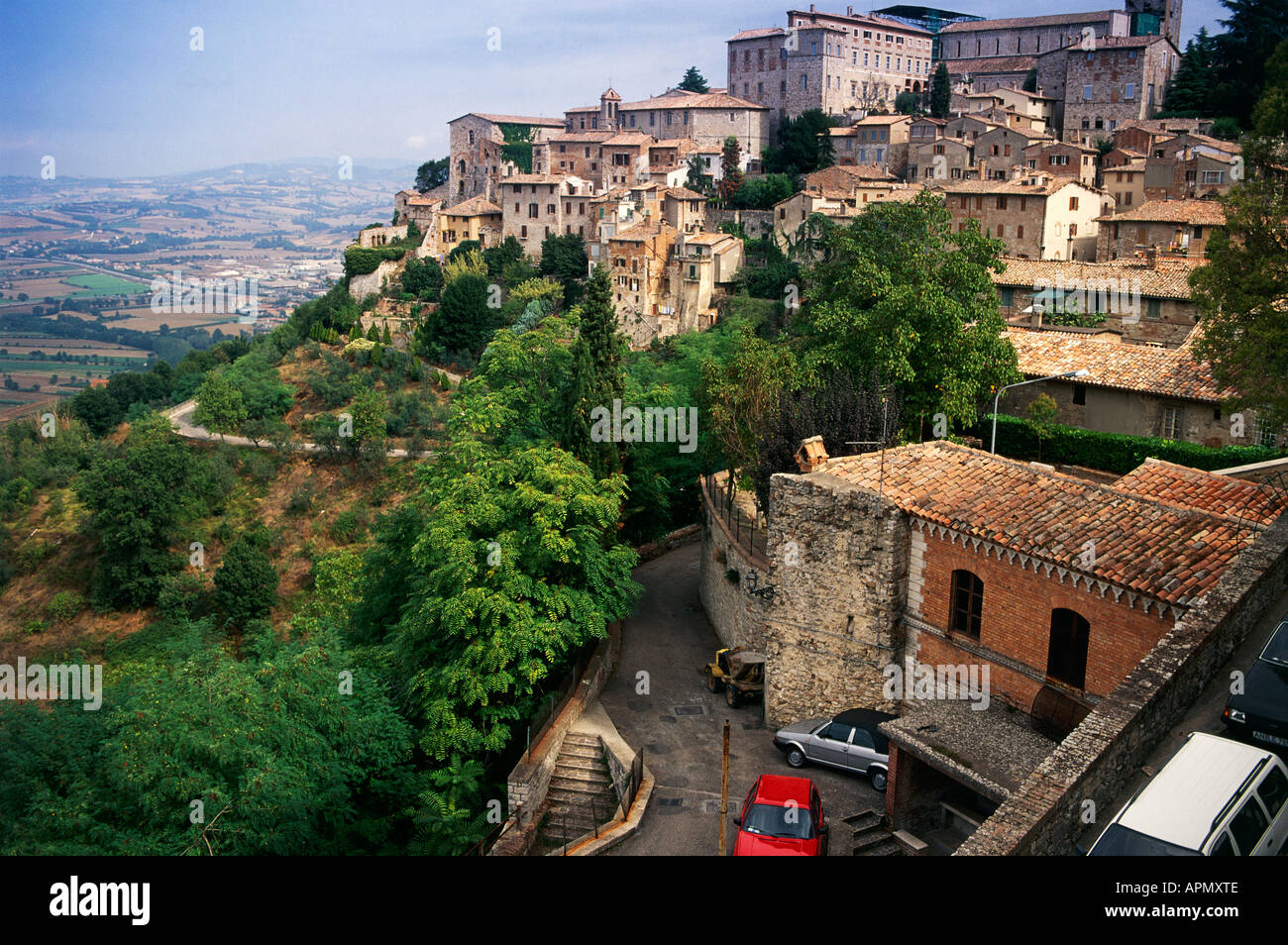 The buildings of the medieval town of Todi topped with tiled roofs and ...