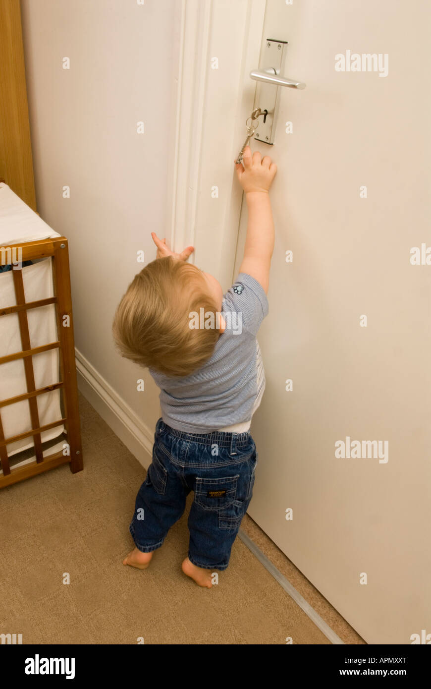 baby boy eleven months old reaching for keys attempting to unlock door ...