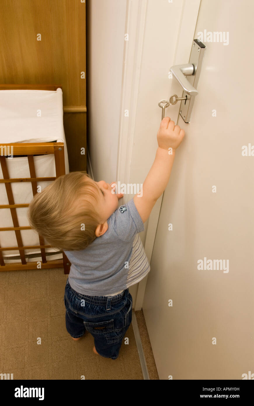 baby boy eleven months old reaching for keys attempting to unlock door ...