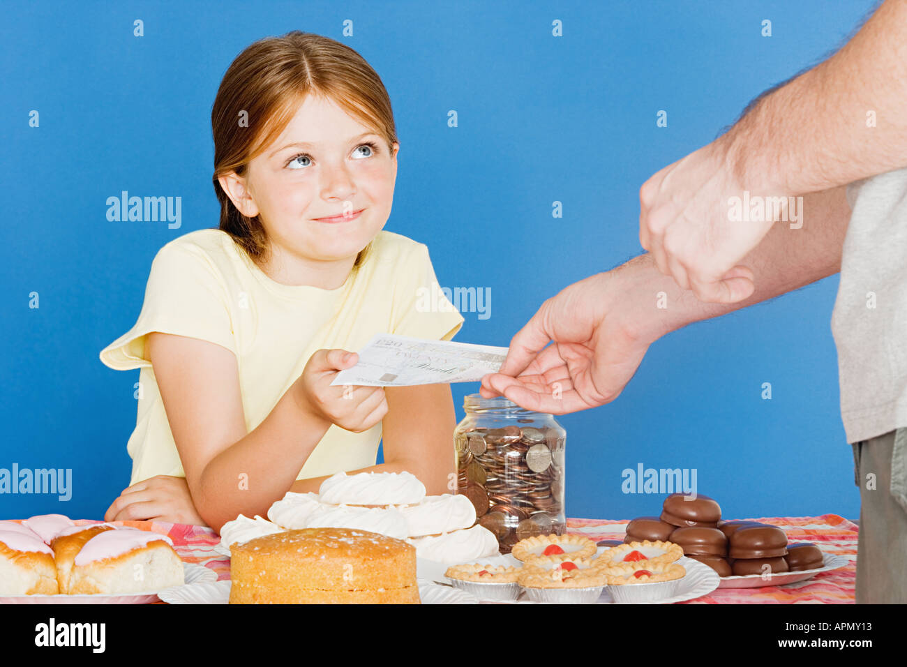 Man buying cake from girl Stock Photo - Alamy