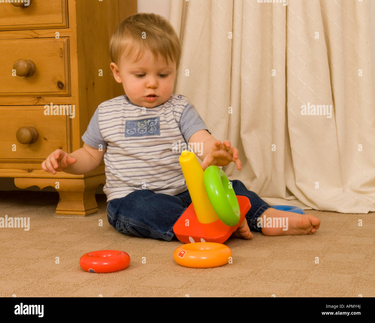 Baby boy eleven months old playing with graded rings toy Stock Photo ...