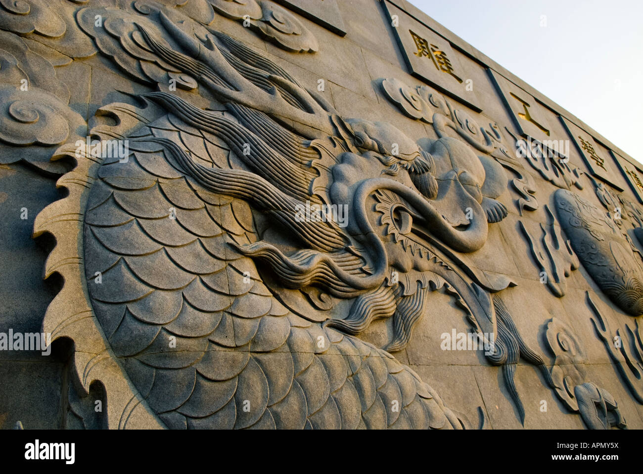 Chinese fire breathing dragon carved on stone wall, Quanzhou, Fujjian ...