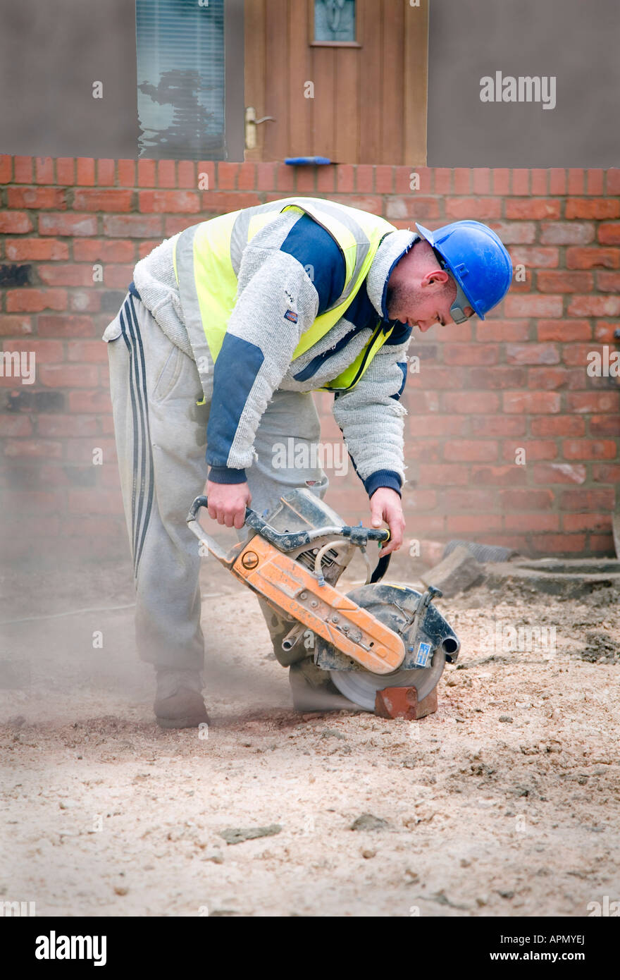 Builder Cutting Bricks Stock Photo - Alamy