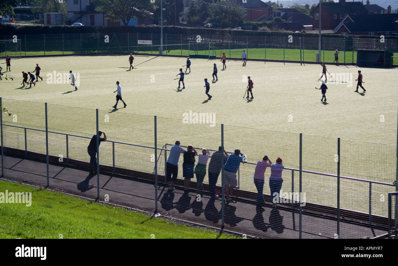 Spectators watching hockey match on artificial pitch surface England UK ...