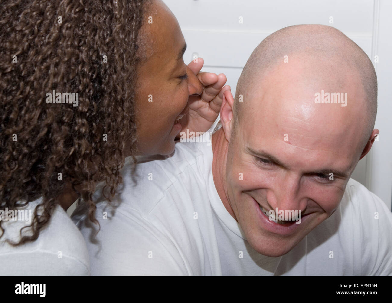 Whisper in ear Stock Photo - Alamy