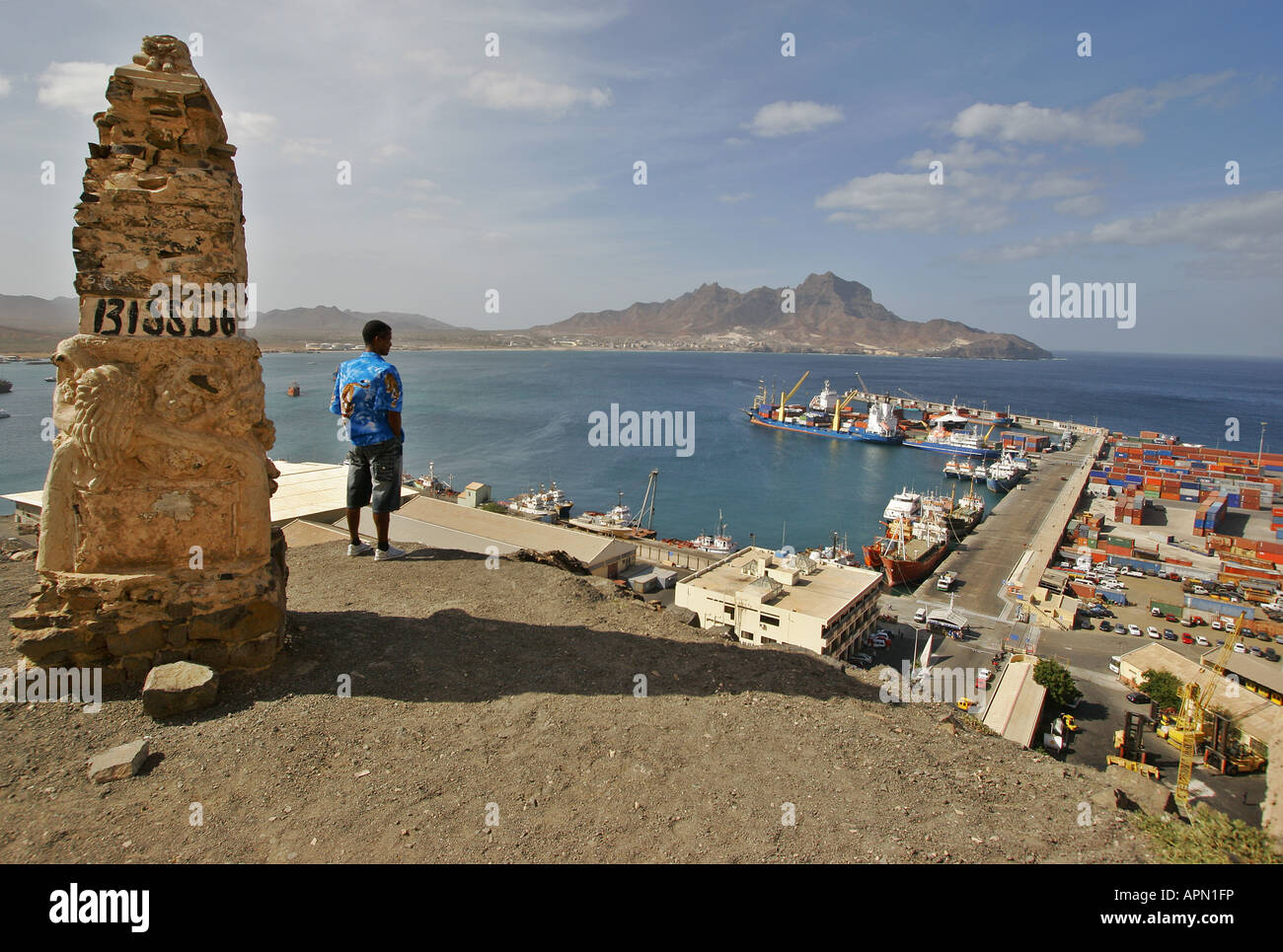 A local man looks over the bustling port of Mindelo on Sao Vicente in ...