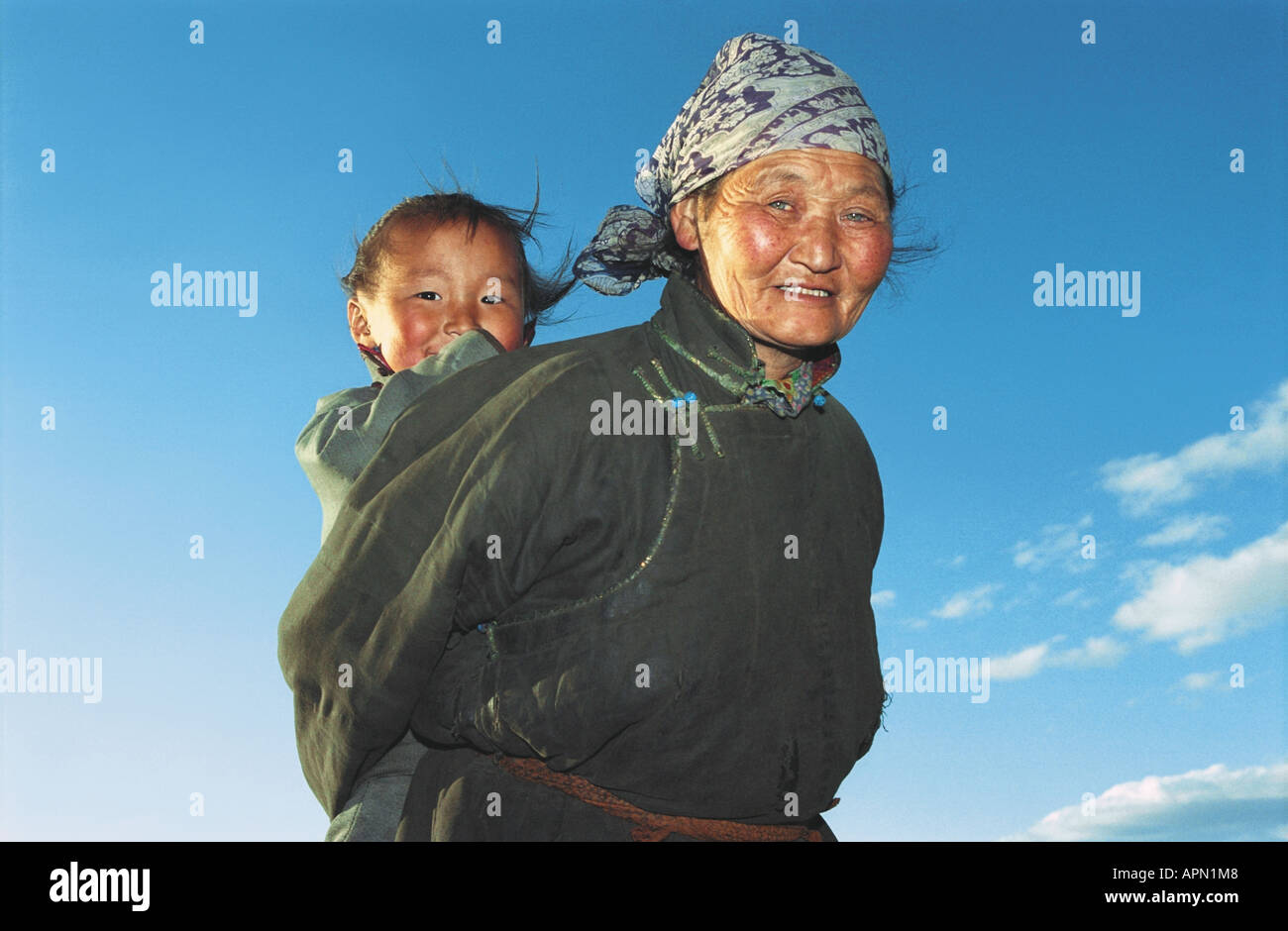 Grandmother carrying granddaughter on shoulders hi-res stock ...