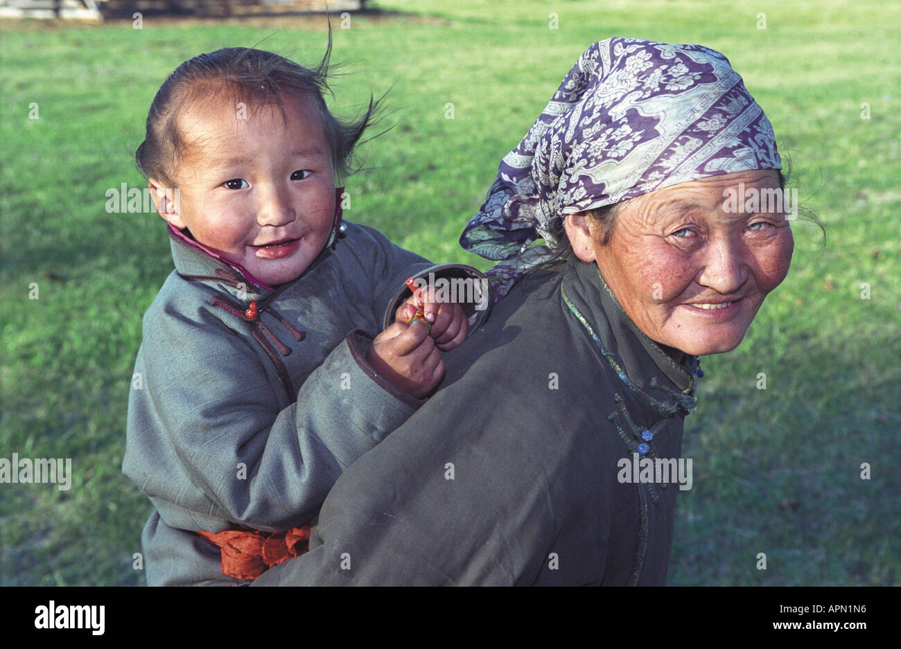 Grandmother carrying granddaughter on shoulders hi-res stock ...