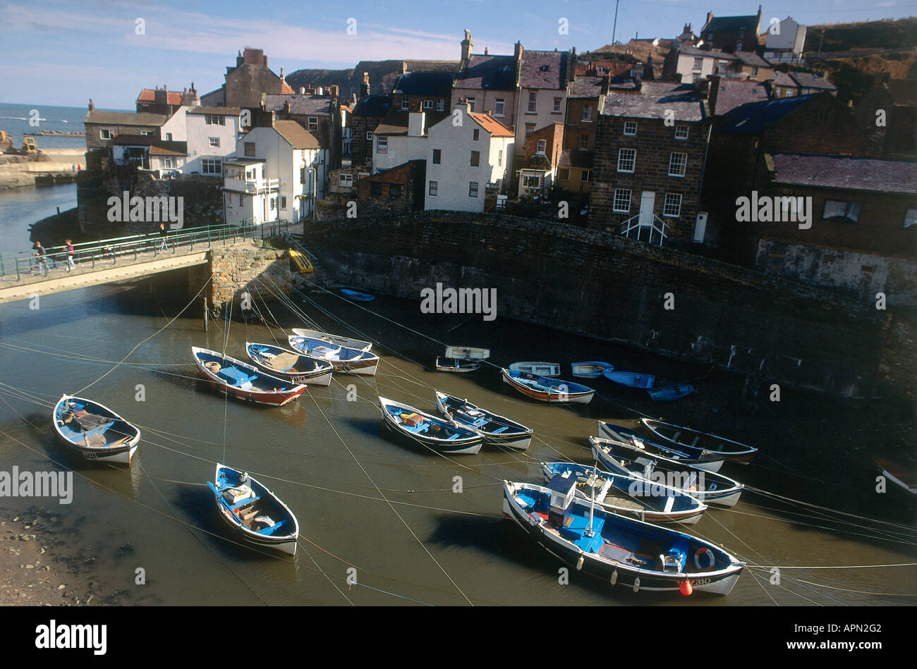Tangled lines mooring the cobles in Staithes harbour North York Moors ...