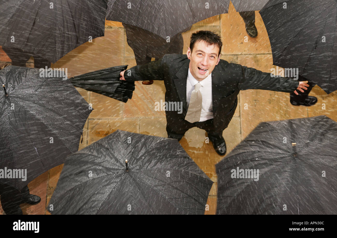 Man standing in the rain with umbrella Stock Photo - Alamy