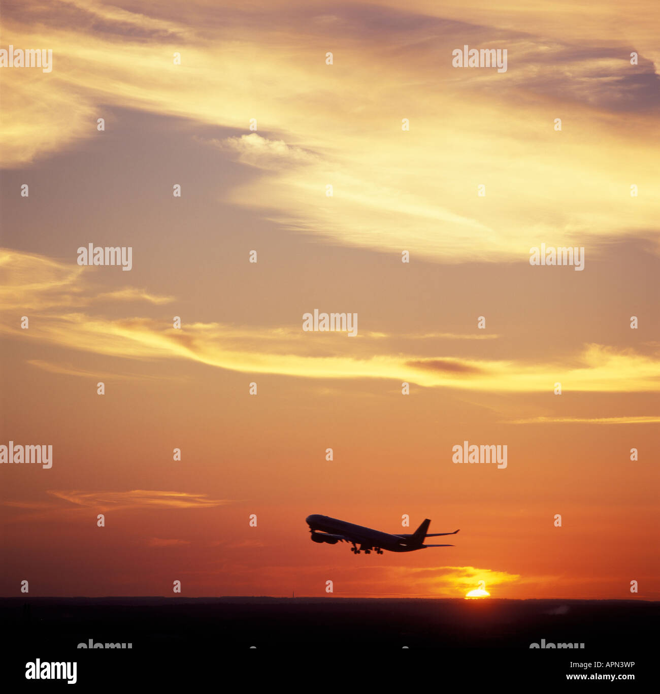 Plane taking off at sunset Stock Photo - Alamy