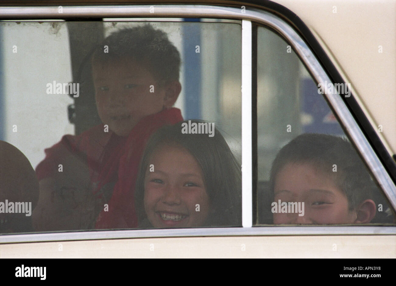 Children making faces through car window. Kosh Agach village. Altai ...