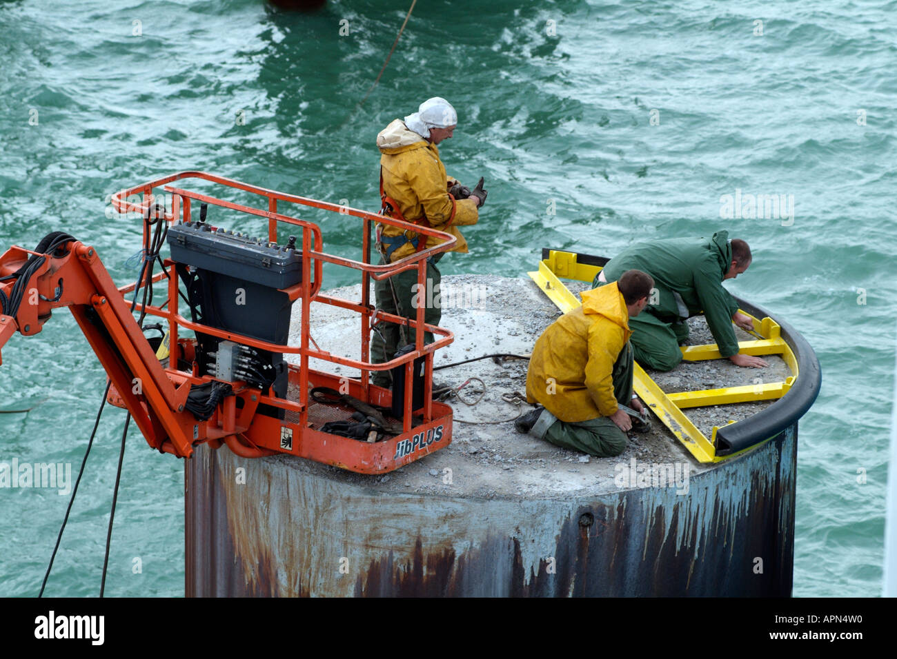 Marine engineers working on large concrete berthing pile in the port of ... Marine engineers working on large concrete berthing pile in the port of ...