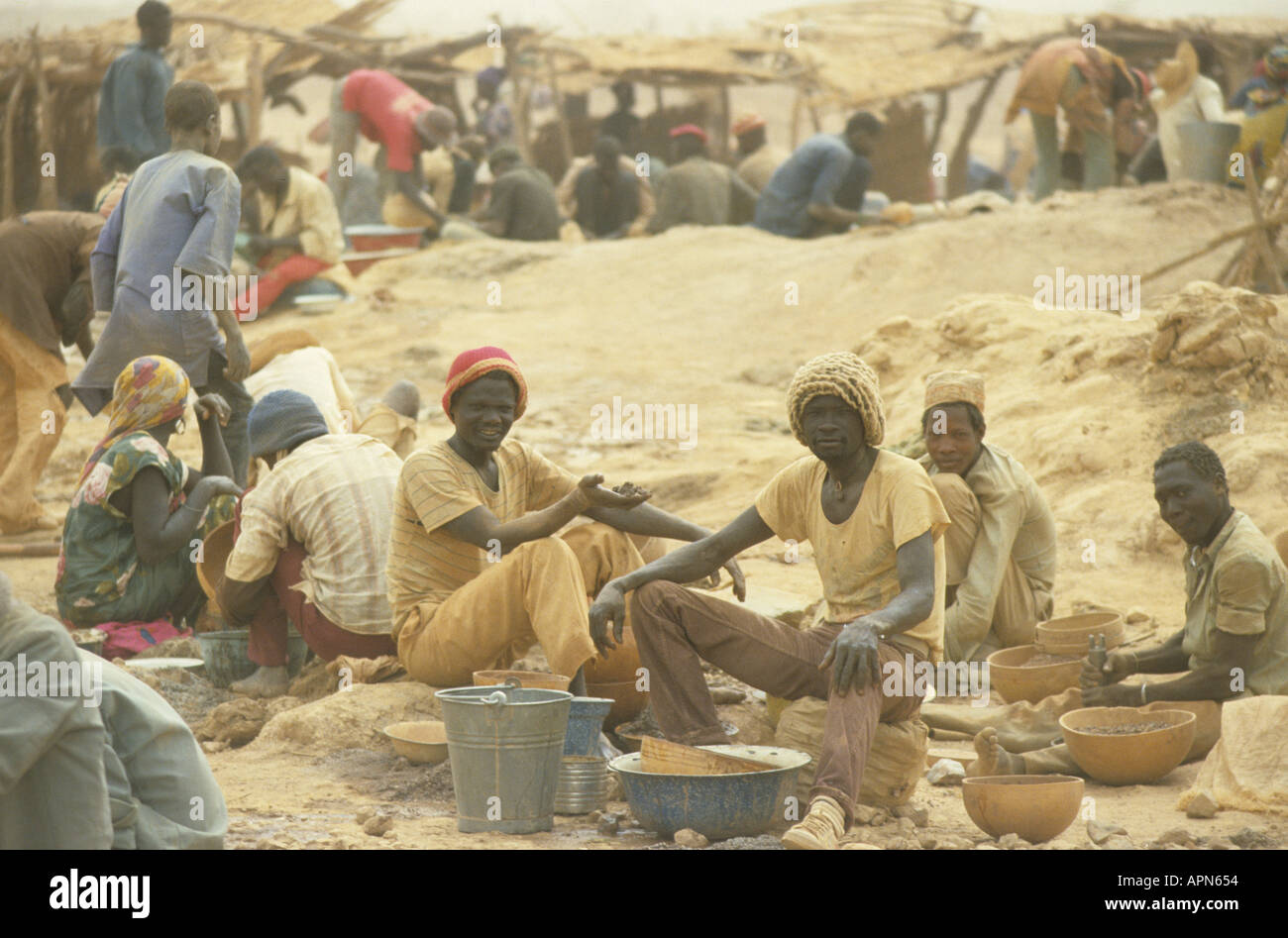 Gold rush prospectors working ina dust storm in the northern Sahel of ...