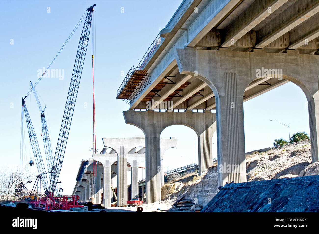 Bridge under construction with industrial construction cranes Stock ...