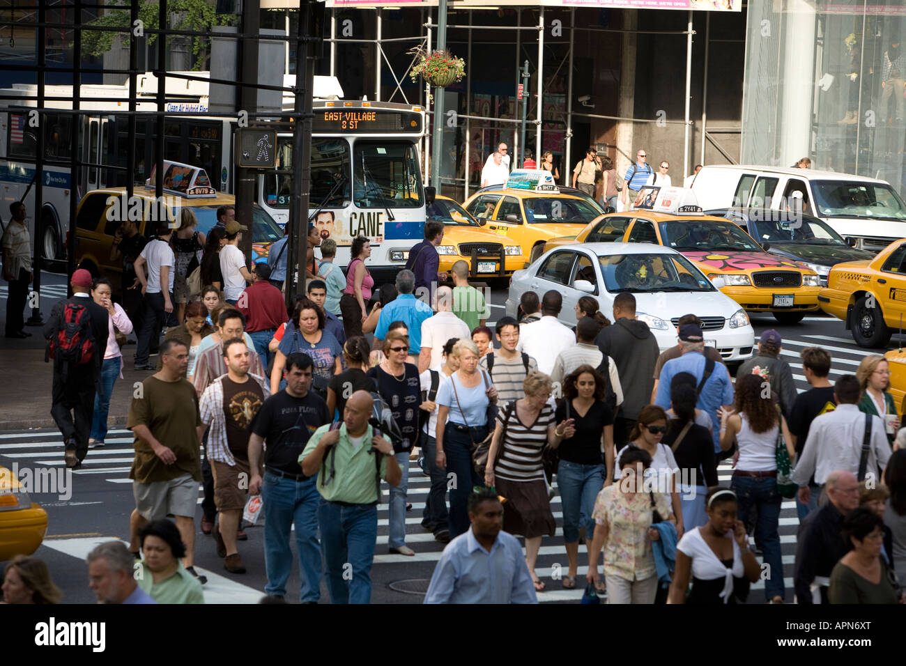 Crowded pedestrian crosswalk at 5th Avenue and 42nd Street in New York ...
