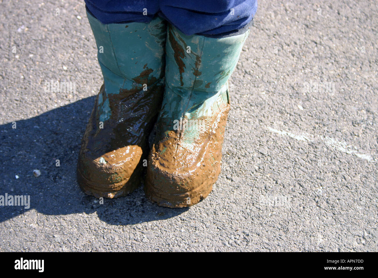 child standing with muddy boots Stock Photo - Alamy