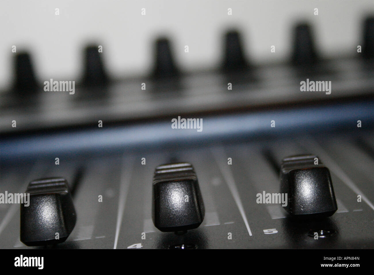 3 motorized faders on a mixing desk Stock Photo - Alamy