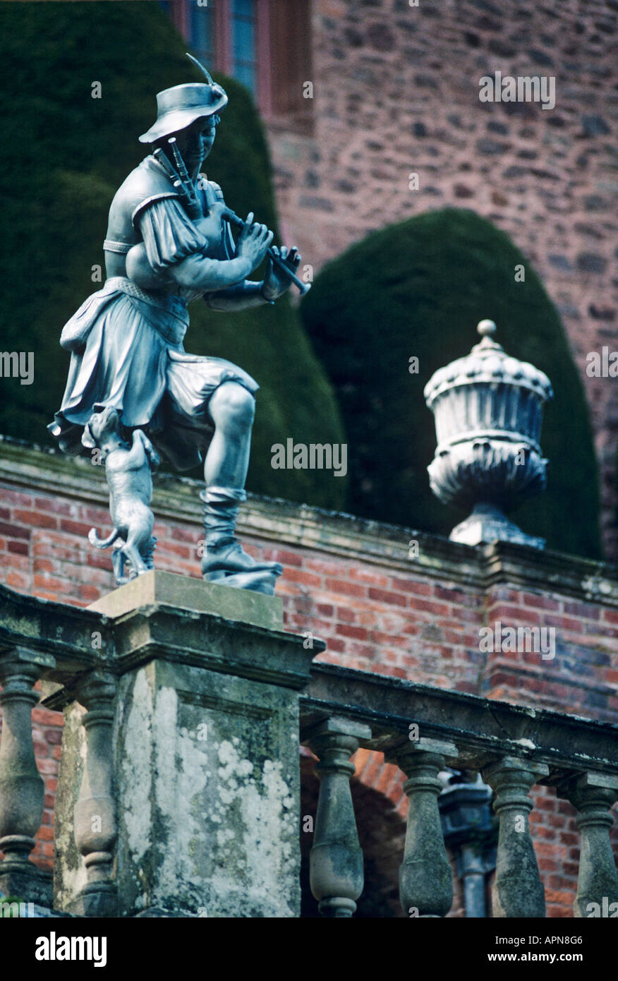 A statue of a piper stands atop the terrace of Powys Castle in ...