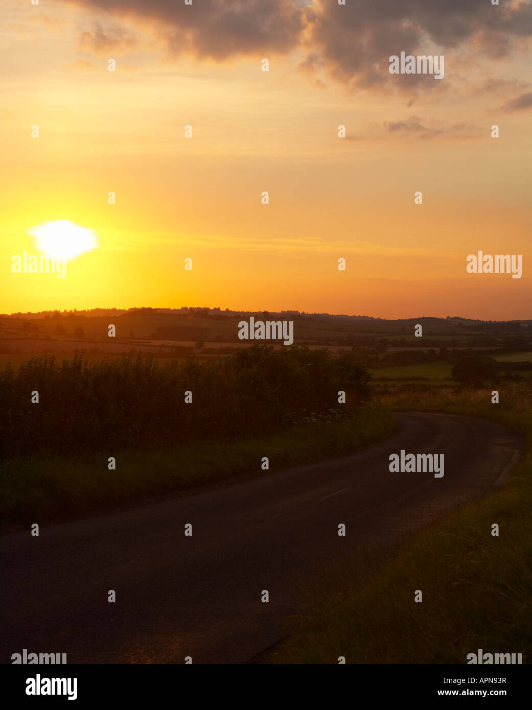 Winding road at sunset Stock Photo - Alamy