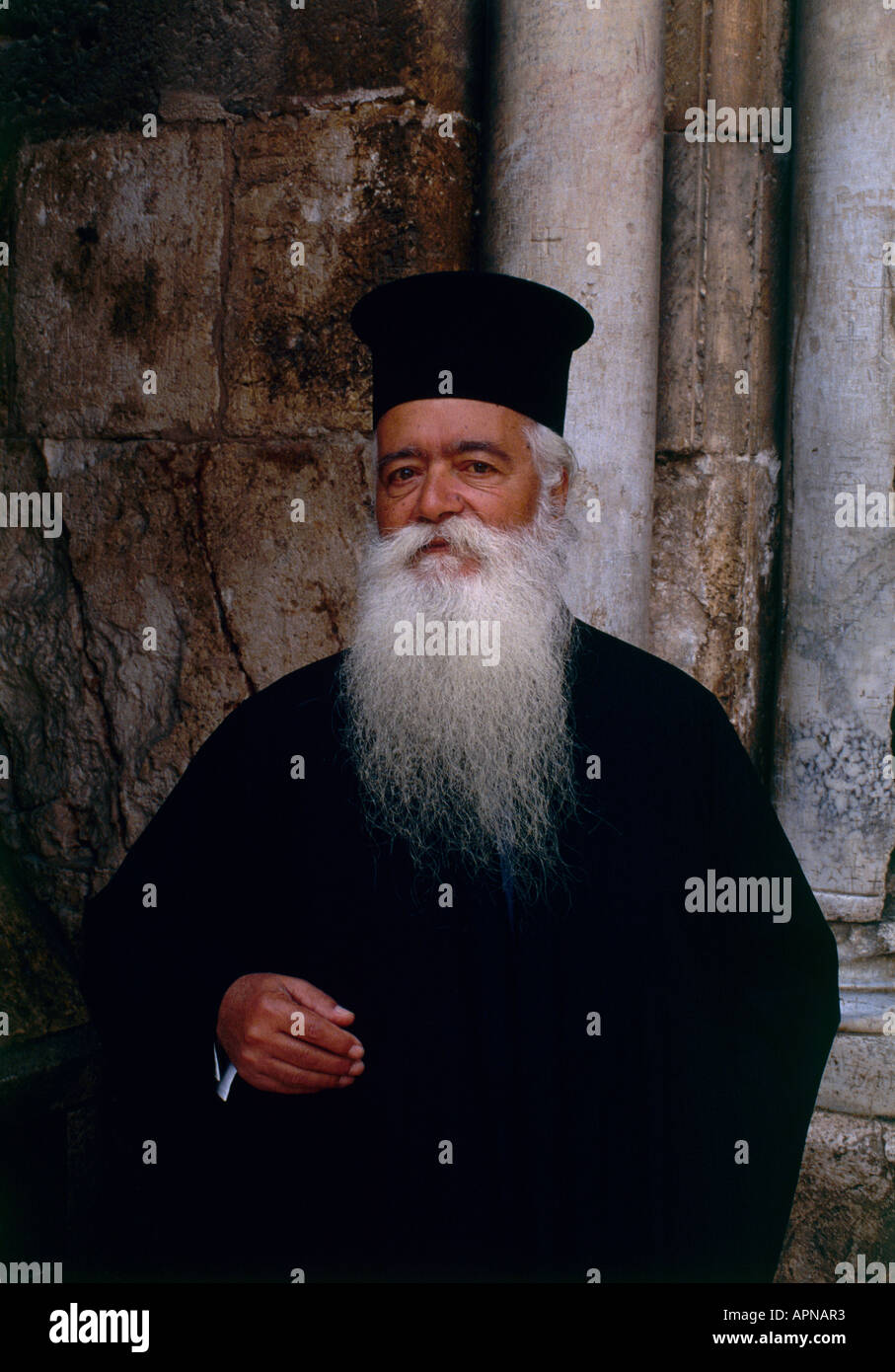 A Greek Orthodox priest standing outside the Church of the Holy ...