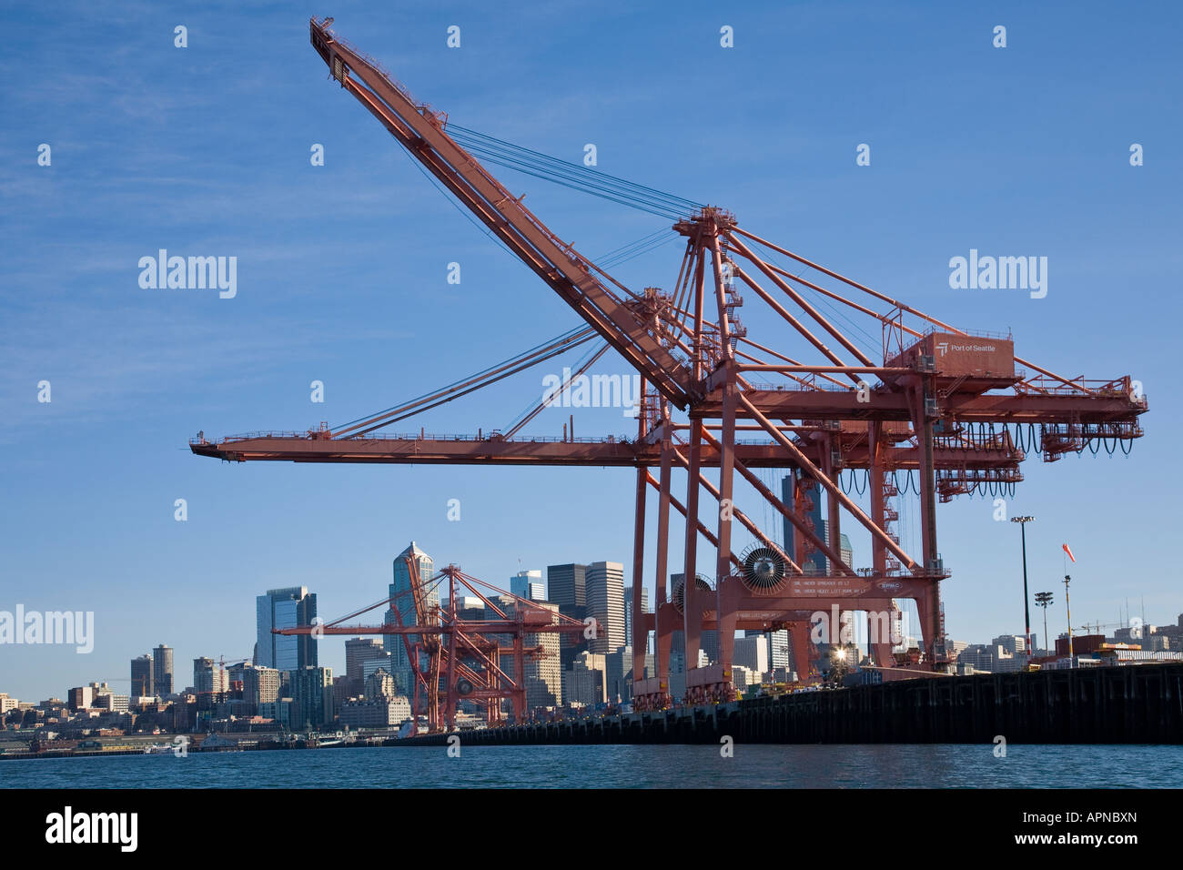 Cranes and dock at port of Seattle with city in background Stock Photo ...