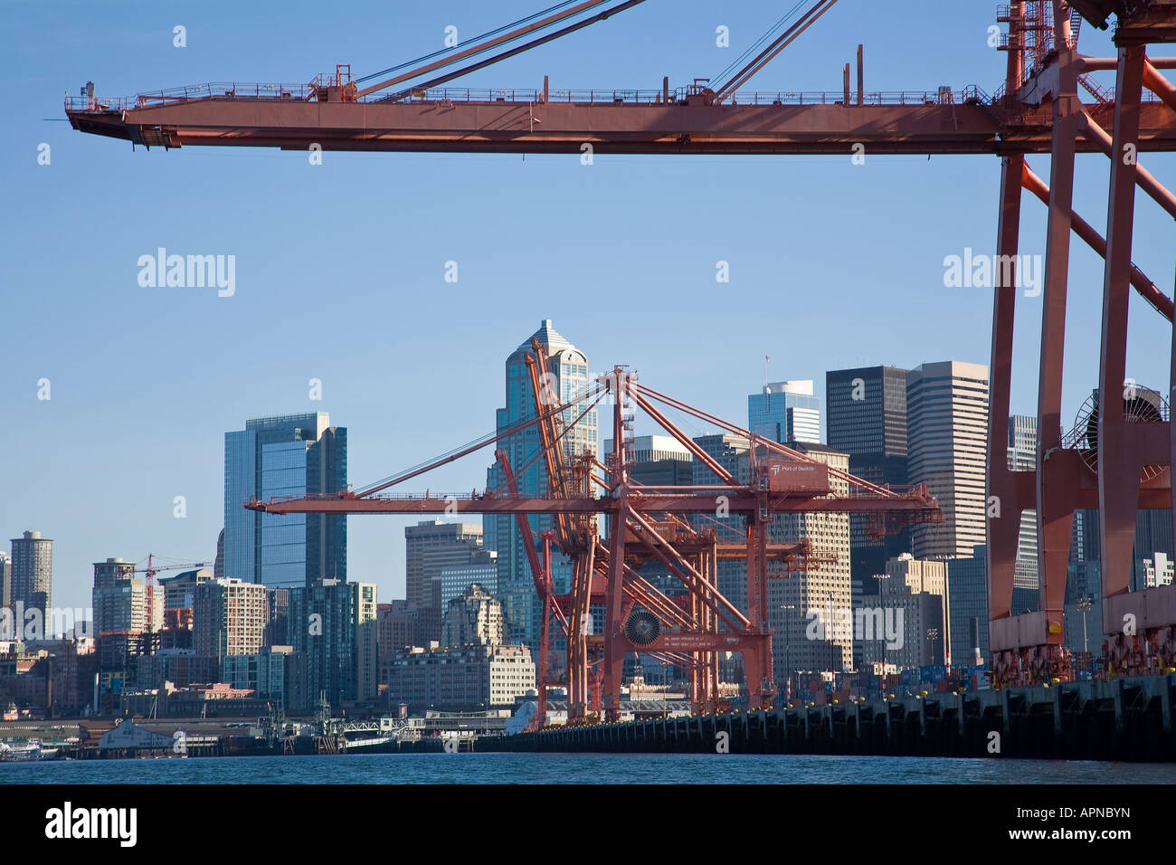 Cranes and dock at port of Seattle with city in background Stock Photo ...