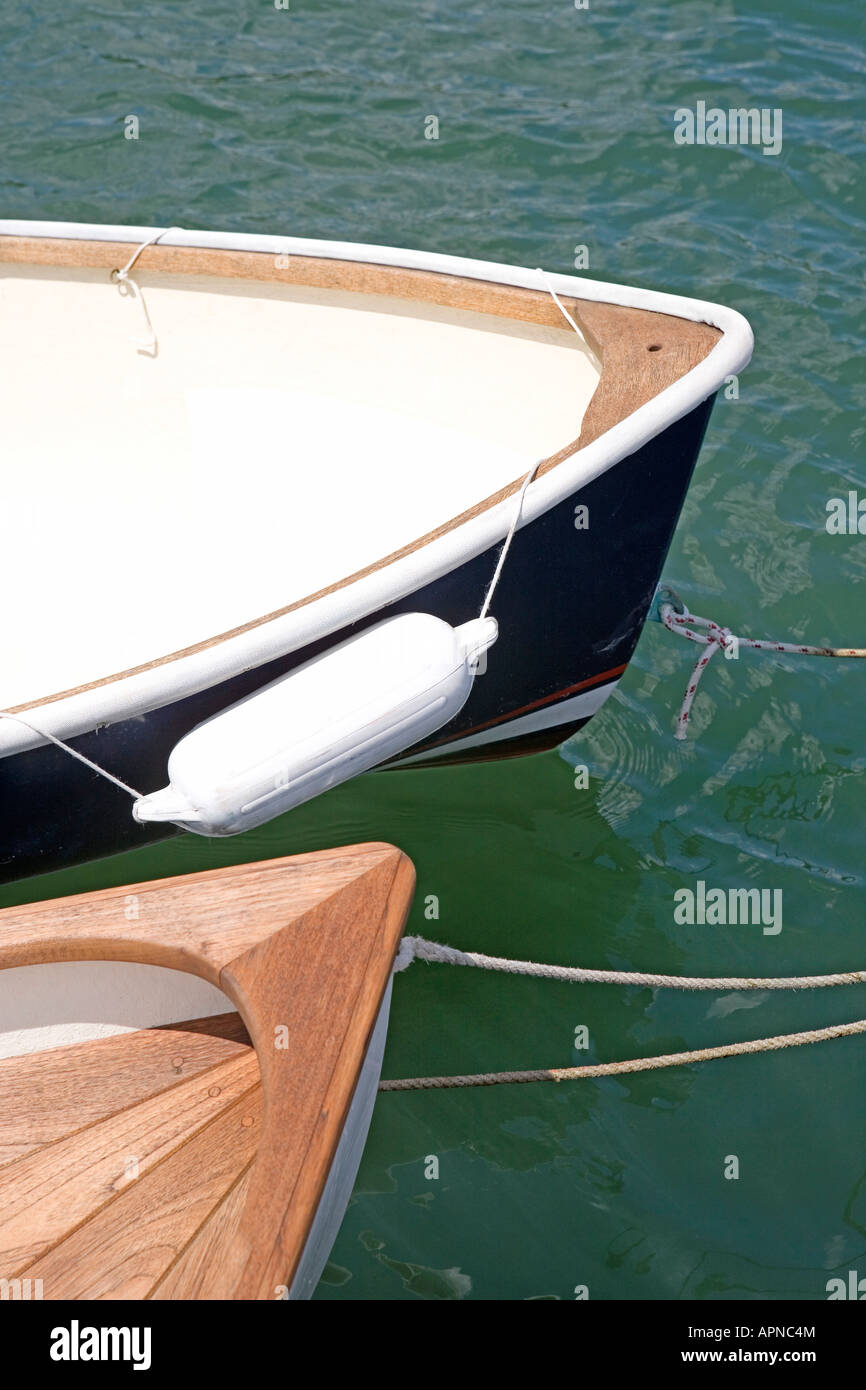 two dinghy bows tied to dock bumper fender close up day outdoor sailing ...