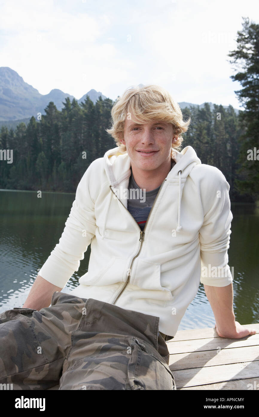 Portrait of teenage boy sitting on jetty, Cape Town, South Africa Stock ...