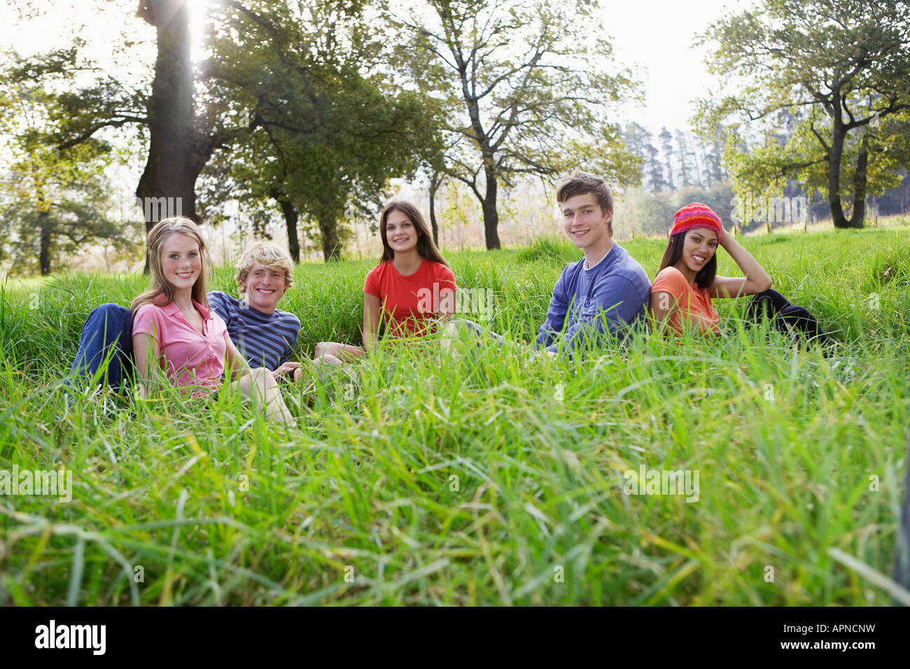 Five teenagers sitting in field (portrait Stock Photo - Alamy