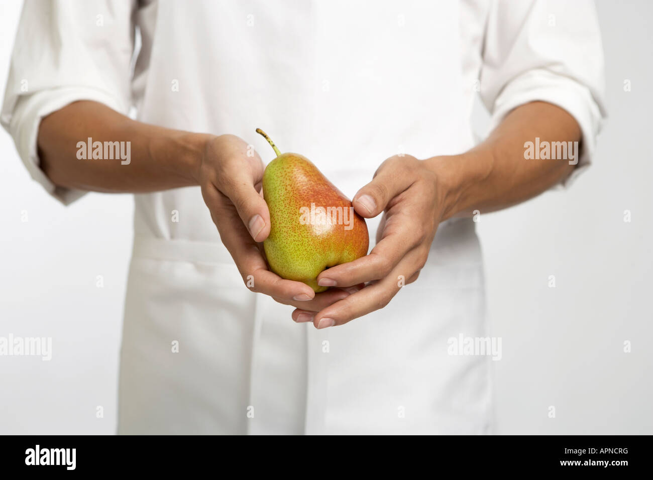 Chef holding pear (mid section Stock Photo - Alamy