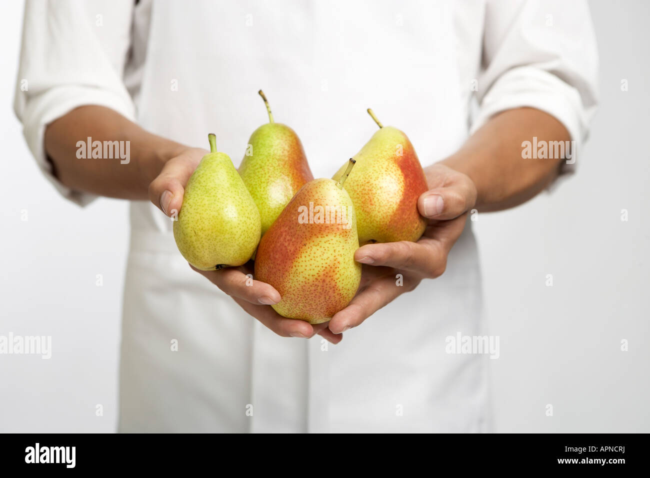 Chef holding pears (mid section Stock Photo - Alamy