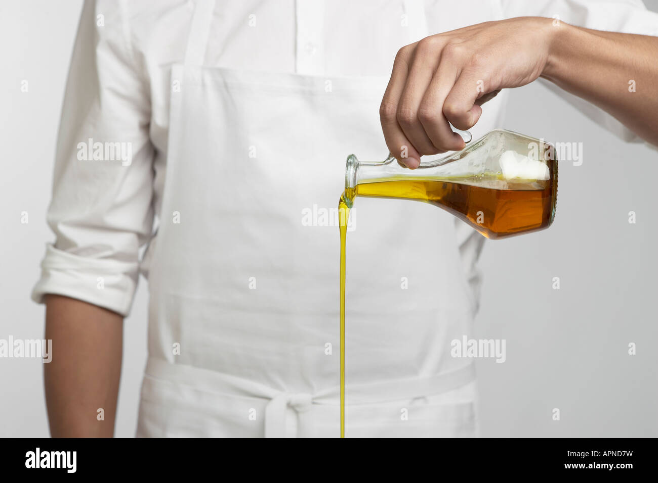 Chef pouring olive oil (mid section Stock Photo - Alamy