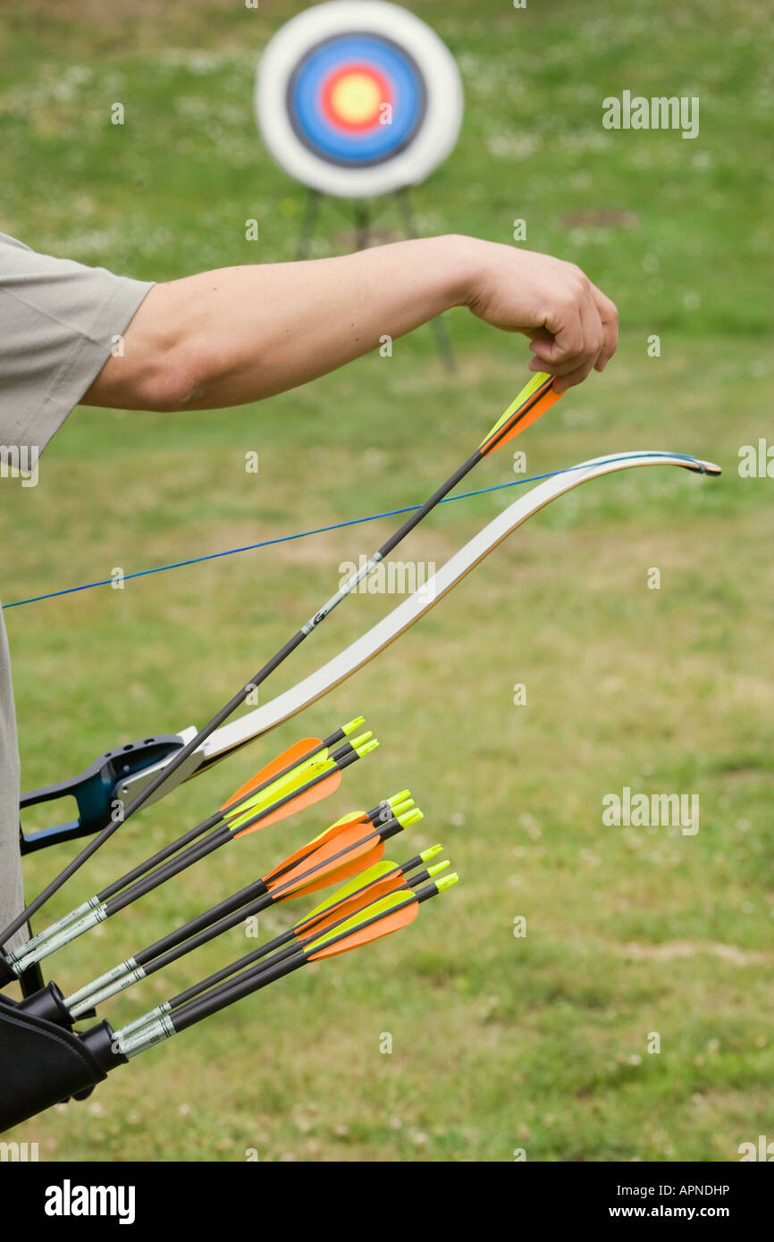Archer taking arrow from holder (focus on foreground Stock Photo - Alamy